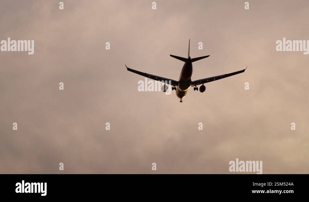 Against the backdrop of picturesque clouds, a passenger plane coming in ...