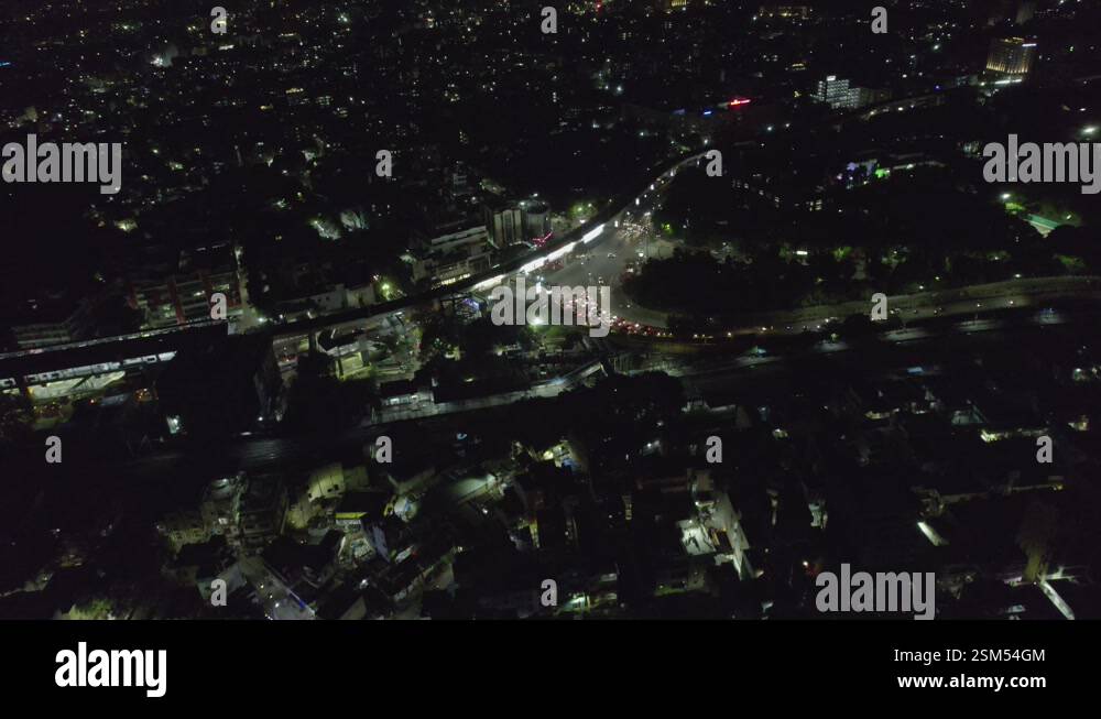A main intersection signal in a city in India during rush hour at night ...