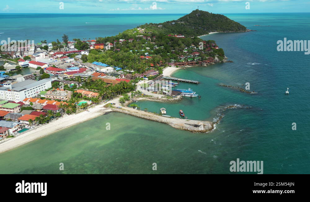 Drone shot of the blue waters surrounding Haad RIn Pier in Thailand ...
