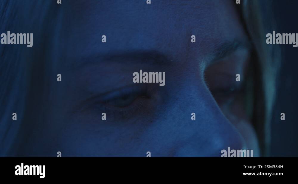 Macro of a beautiful woman's eyes looking around in a dark room Stock ...
