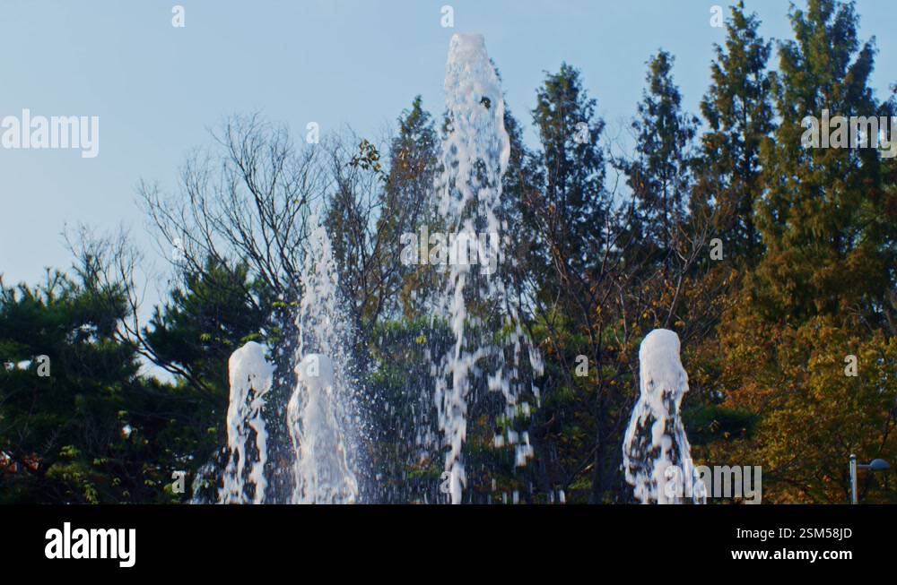 A close-up view of fountains water in the park in the fall autumn ...