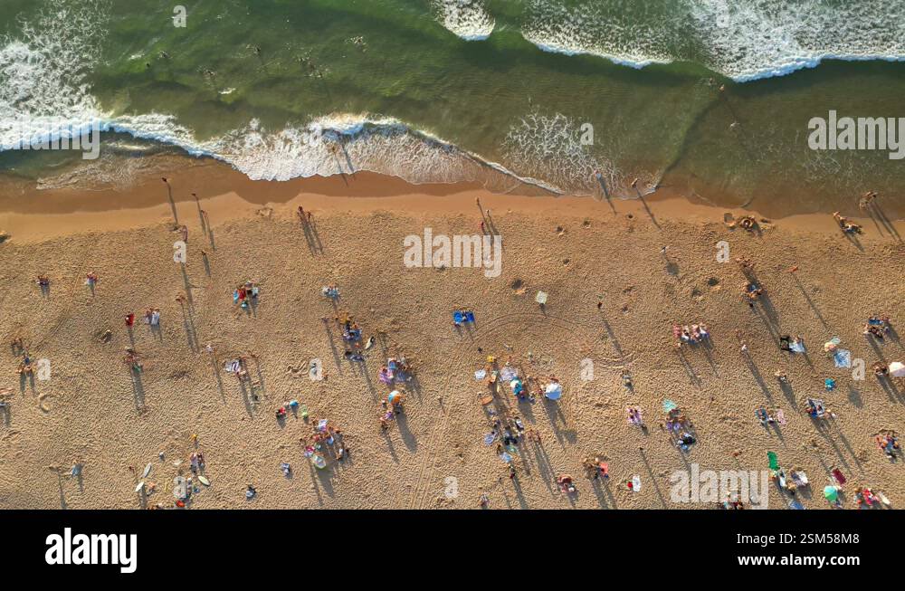 Eagle's eye view over bathers on the guincho beach with the waves Stock ...