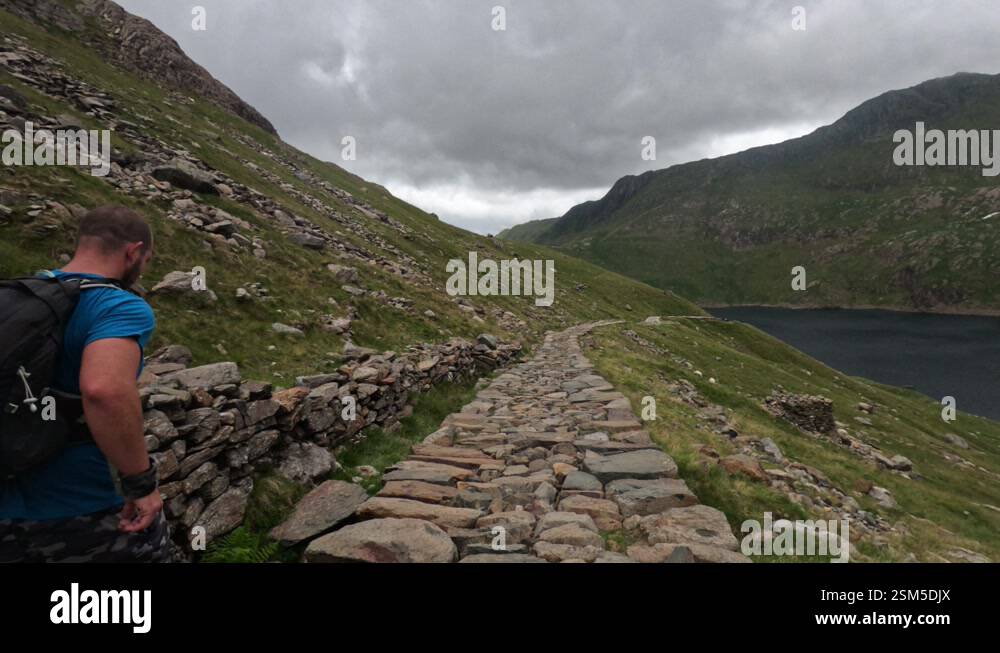 Two men racing down Snowdon as part of 3 peaks challenge, Wales Stock ...