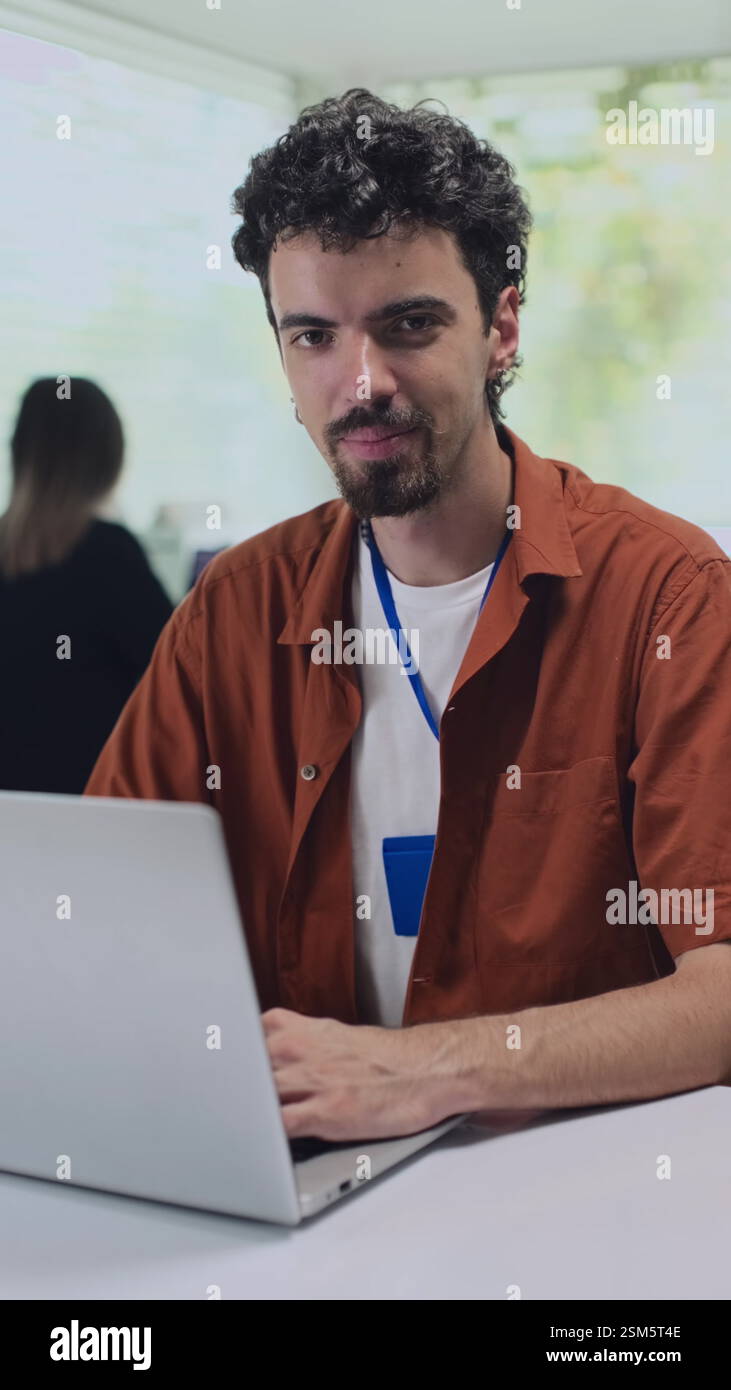 Cheerful Manager Looking at Camera while Sitting at Desk in Office ...