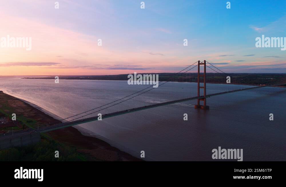 Humber Bridge at golden hour, a serene passage for cars below Stock ...