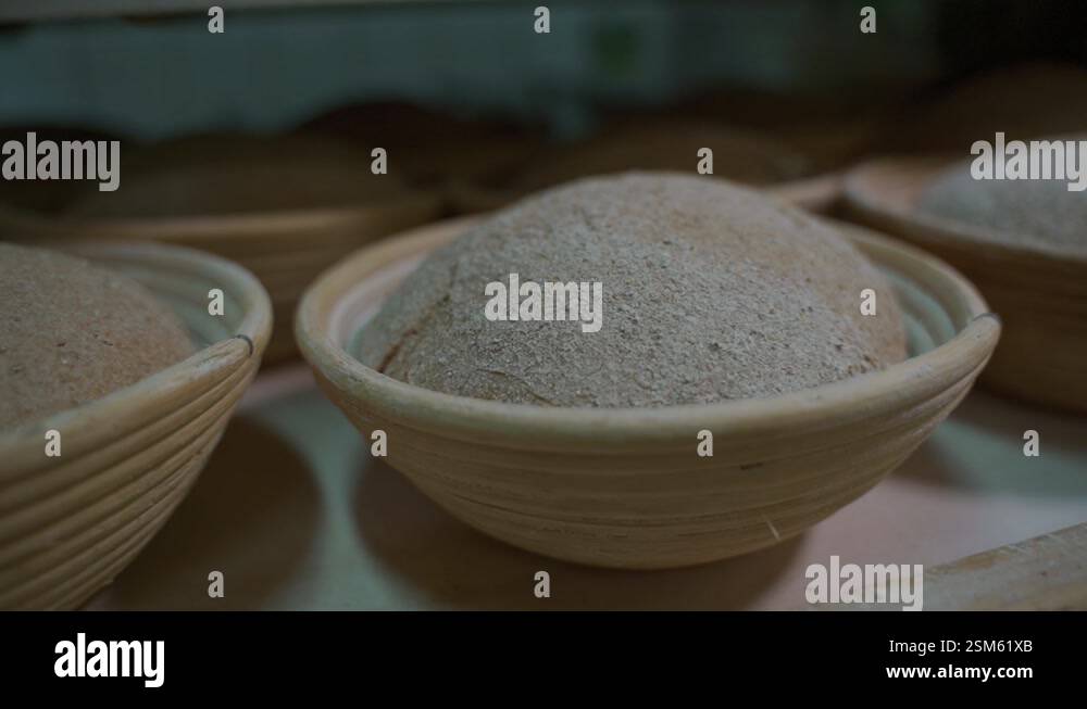 Bread dough blank lies in a beautiful old baking pan in a bakery ready ...