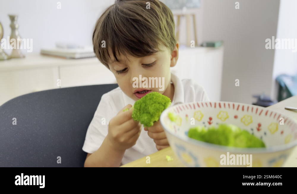 Little Boy Love Eating Broccoli with His Hands During a Healthy ...
