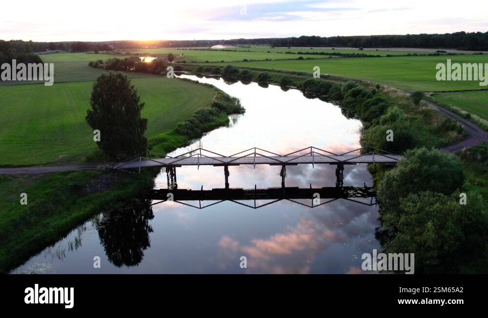 Fly over river with bridge, summertime at sunset in Sweden Stock Video ...