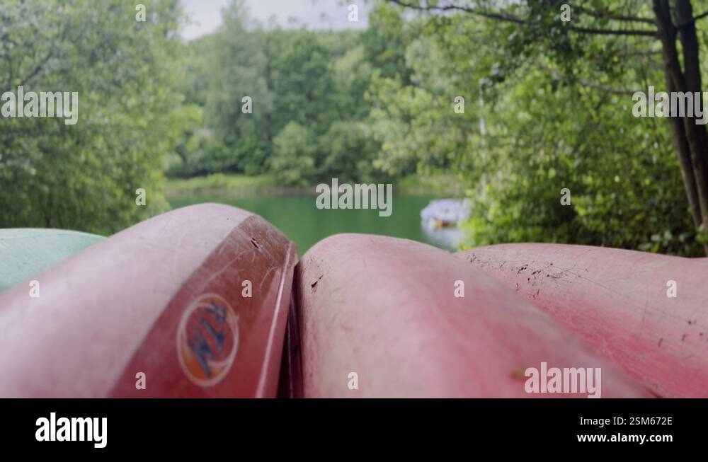 Red boats canoes lie upside down on the shore of a lake Stock Video ...