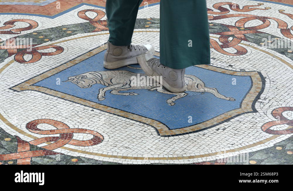 People Spinning on the Bull Mosaic in the Galleria Vittorio Emanuele II ...