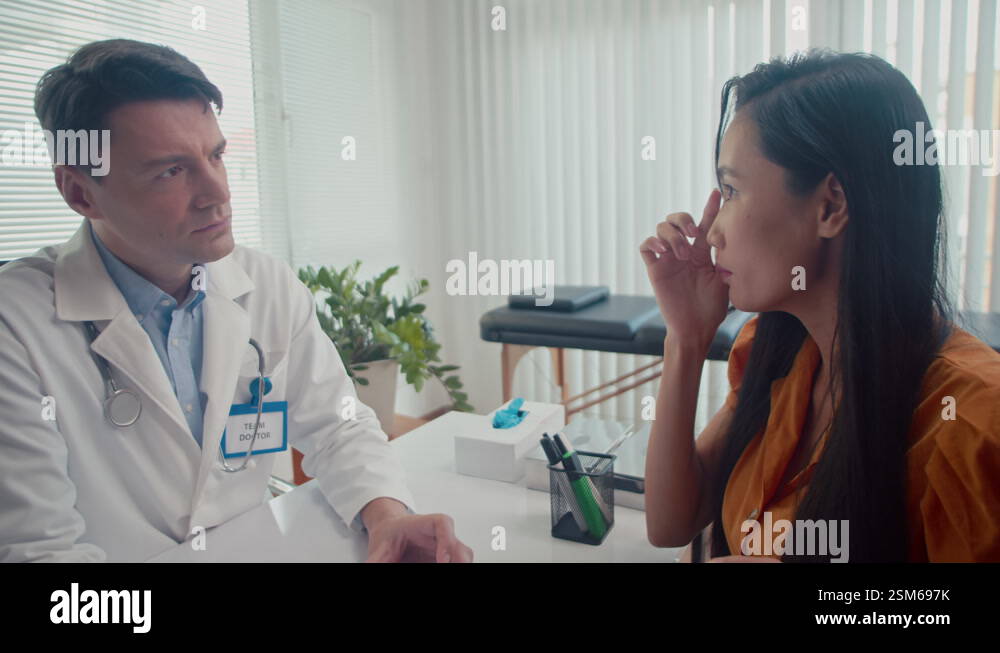 Asian Woman Pointing at Her Nose while Talking to Plastic Surgeon at Clinic Stock Video Footage ...