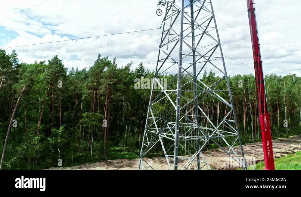 Close-up aerial view of the construction of the poles for new high ...