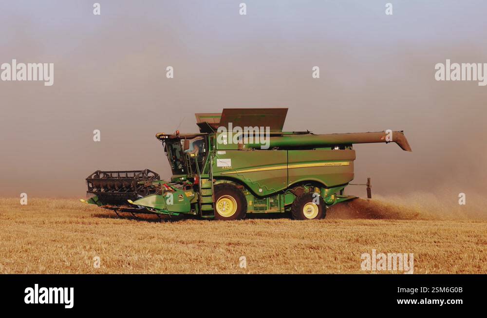 John Deere grain harvester at work. Combine harvester with straw ...