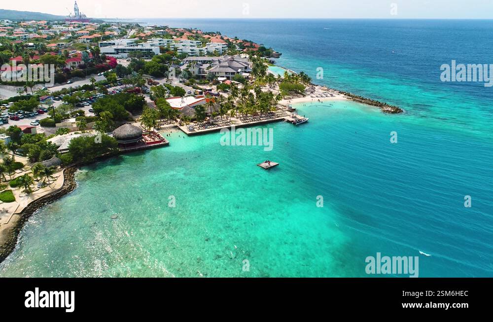 Swimmers jump off floating dock by Zanzibar beach Jan Thiel Curacao ...