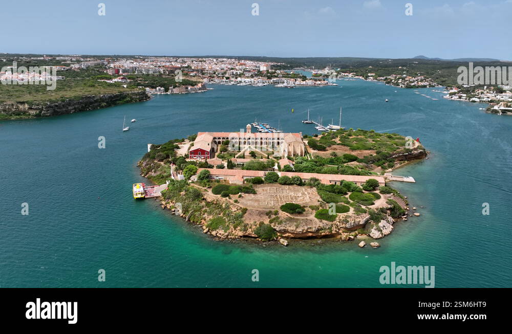 Minorca's coastal town, showcasing Illa del Rei in the foreground Stock ...