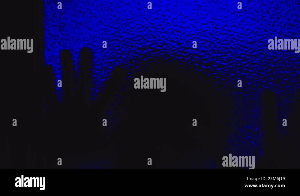 Spine-chilling silhouette of possessed man creeps on glass in the dark ...