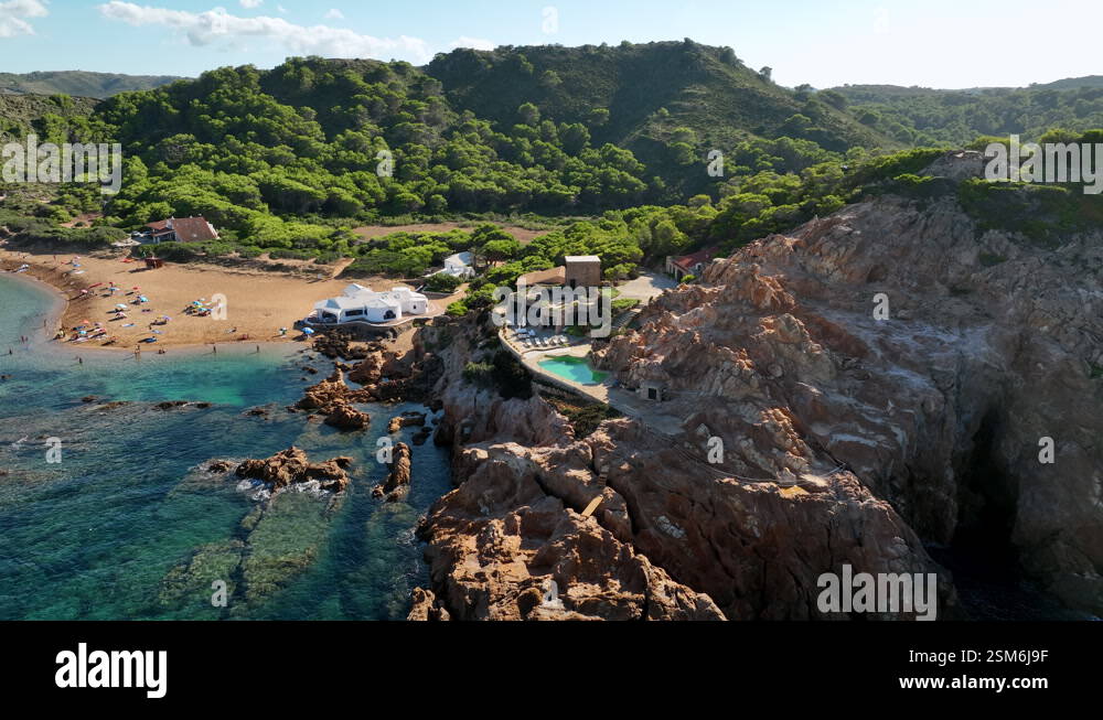 Minorca's Cala Pregonda, where green foliage meets rocky precipices by ...
