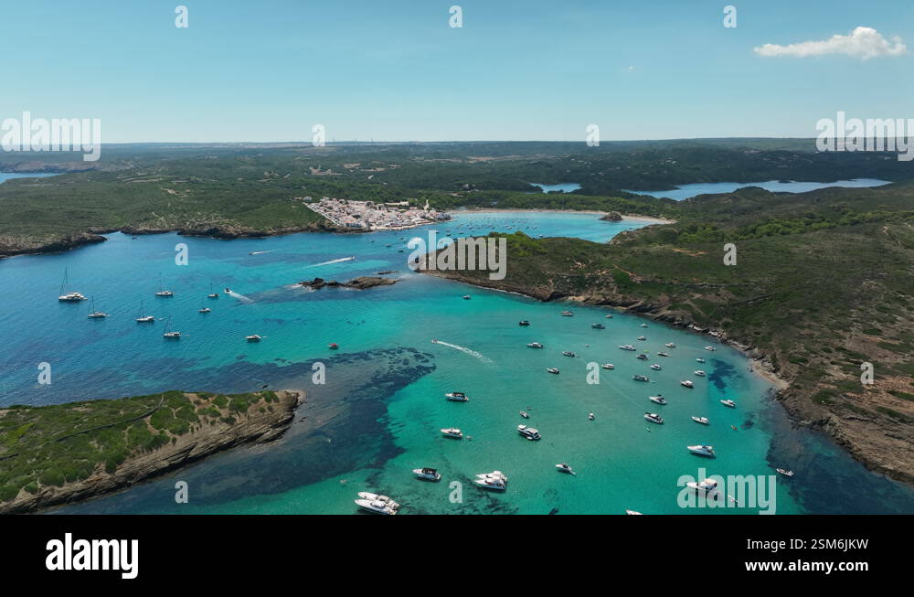 An overhead glimpse of Minorca's vibrant coastal hues and serene boat ...