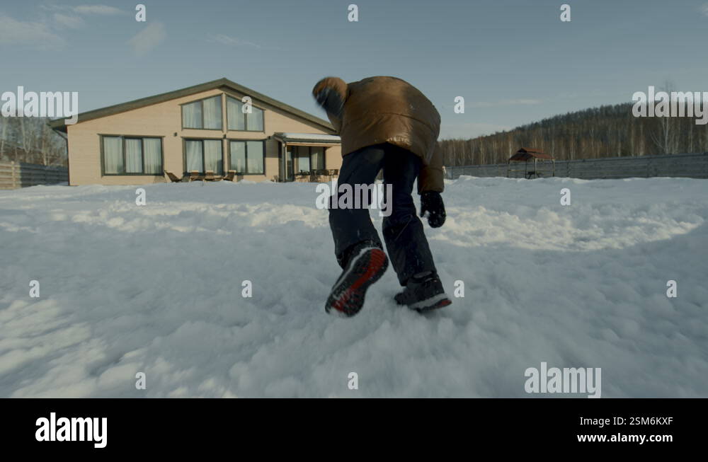 Child Escaping from Friends Throwing Snowballs during Play Fight Stock ...