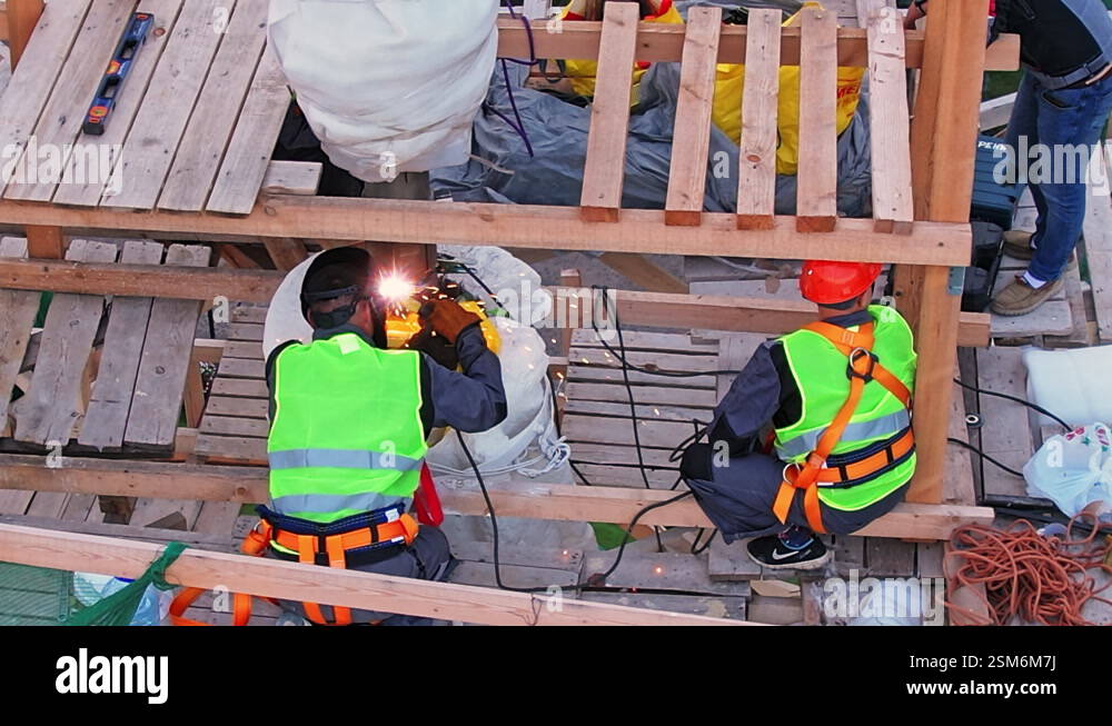 Employee uses welding machine to secure star on roof Stock Video ...
