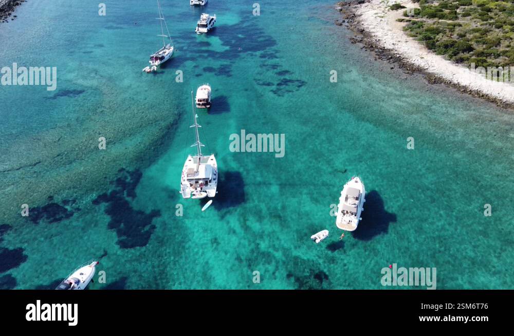 Yachts and cabin cruiser boats of different types and sizes anchored in ...