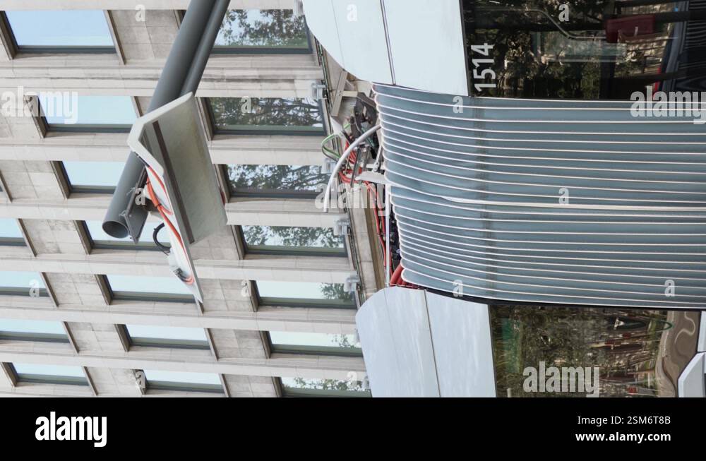Vertical portrait of electric bus charging renewable electricity at the ...