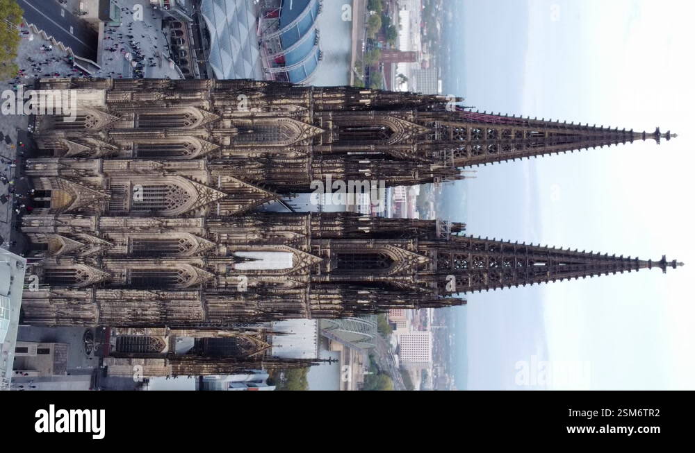 Facade of Gothic Cologne Cathedral with tall twin-spires. Vertical ...