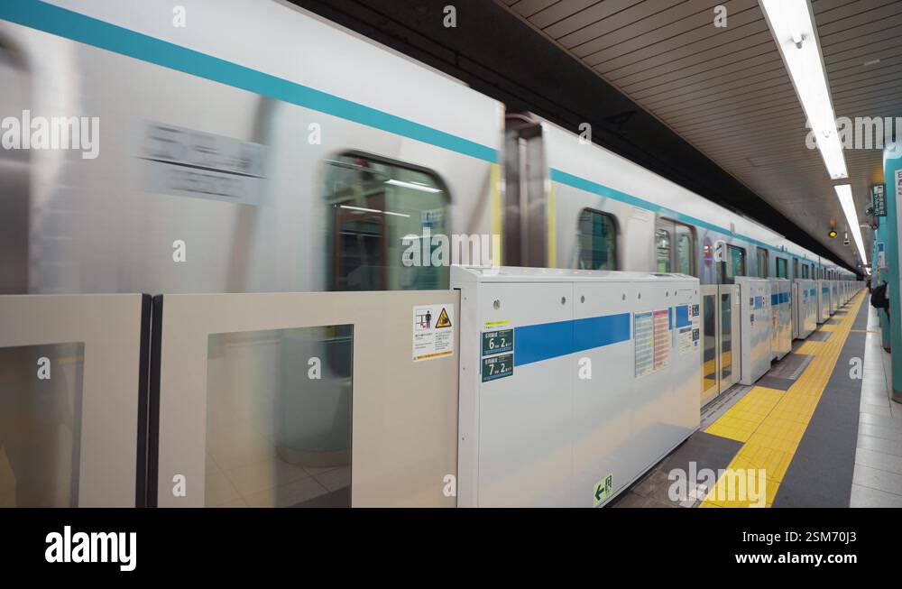 Speed of Metro train on Tokyo metro Tozai line arriving at platform ...