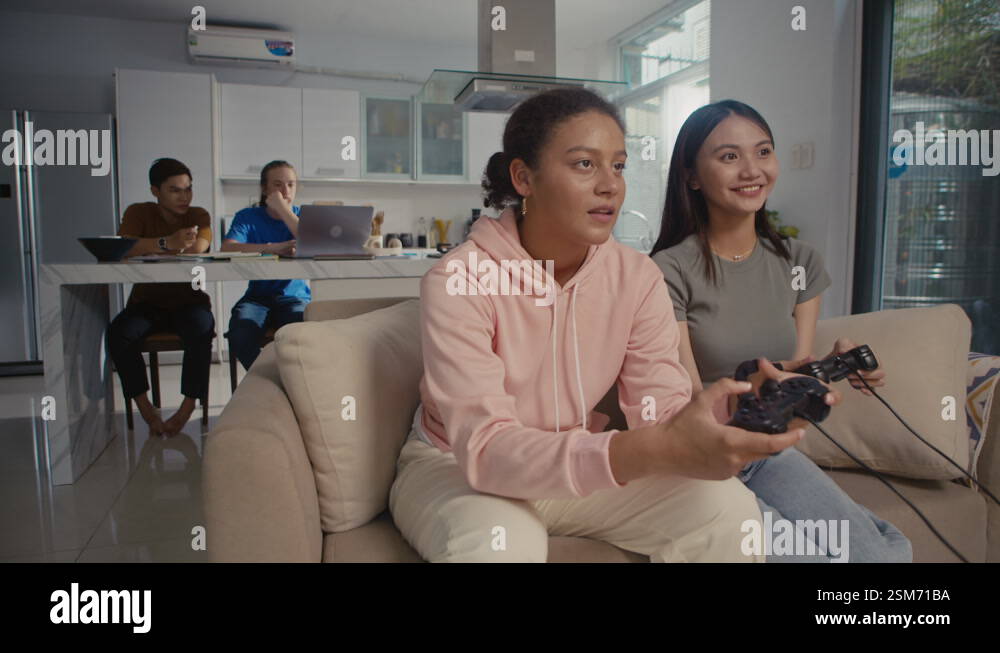Two Young Girls Using Joystick while Playing Video Game at Home Stock ...