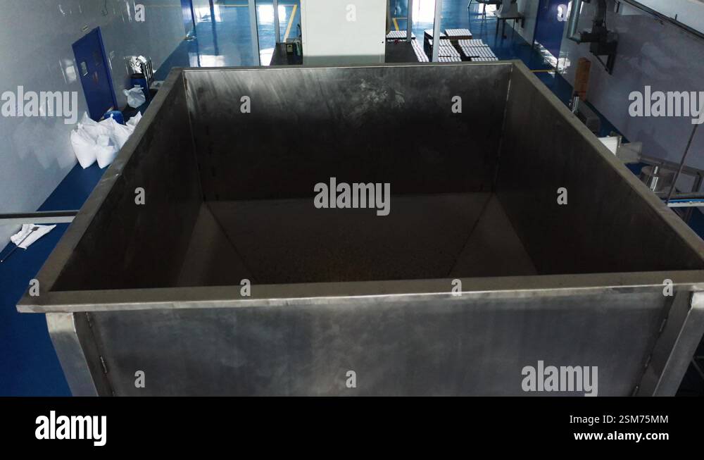 A close-up scene, in a peanut butter factory, high quality peanuts are ...