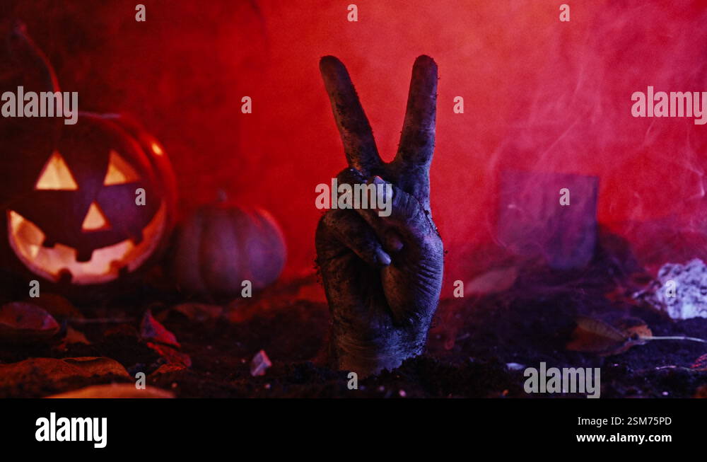 Zombie hand raising two fingers up showing peace from grave.Halloween ...