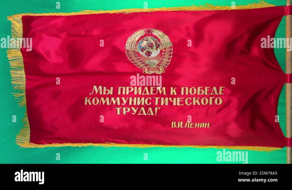 A Soviet parade flag displaying a hammer and sickle emblem flies in ...
