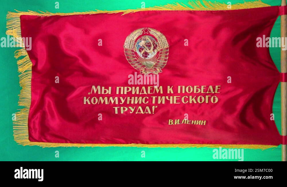 Soviet parade flag with propaganda slogans flies from flag pole with ...