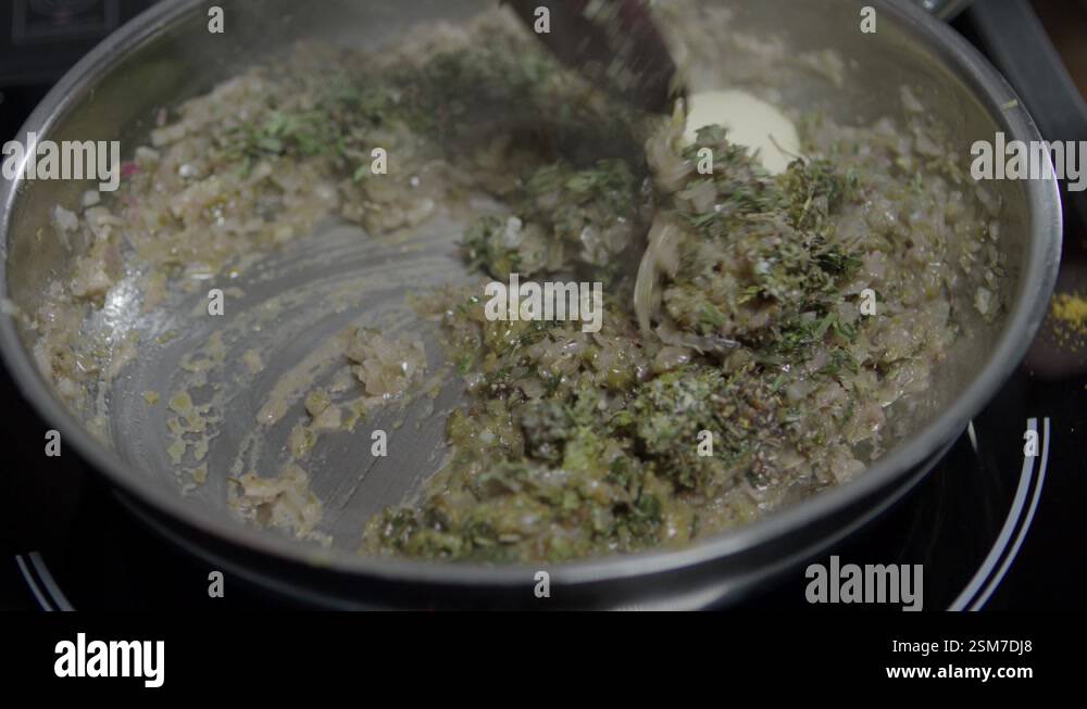 Close-up of a chef mixing ingredients in a metal pan. Preparing a Stock ...