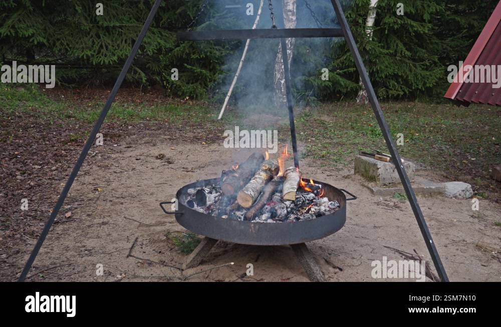 campfire grill or Fire pit grill with burning bright wood in the ...