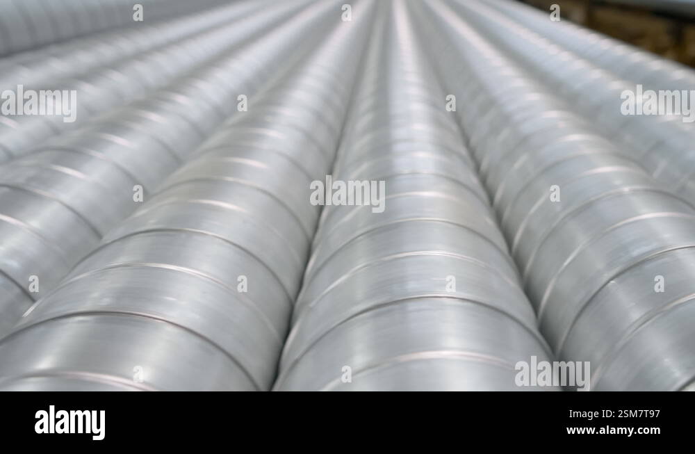 Multiple silver heavy steel pipes manufactured at the industrial ...
