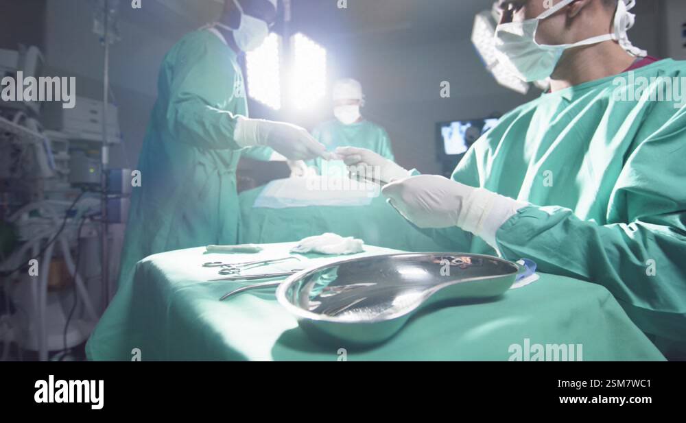 Diverse surgeons using surgical instruments in operating theatre at ...