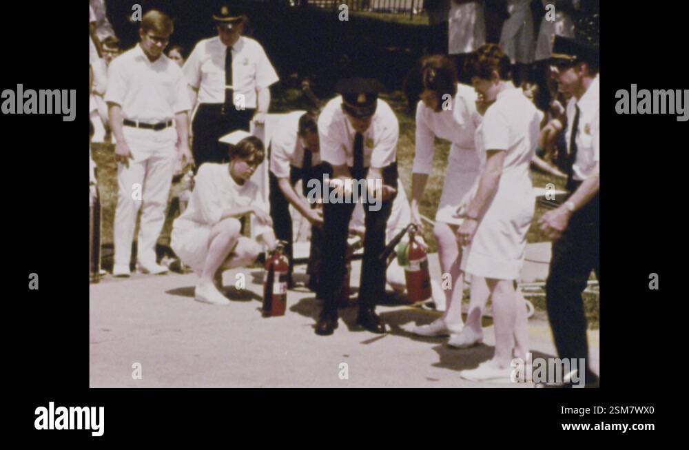 1960s: Nurses being shown how to use a fire extinguisher. Various ...