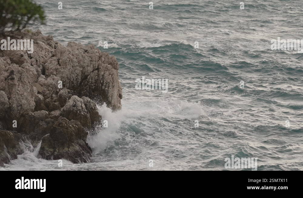 Slow motion sea waves crushing over rocks with soft light Stock Video ...