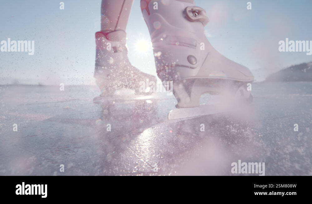 LENS FLARE, SUPER SLOW MOTION, CLOSE UP: Ice flies as lady turns on her ...