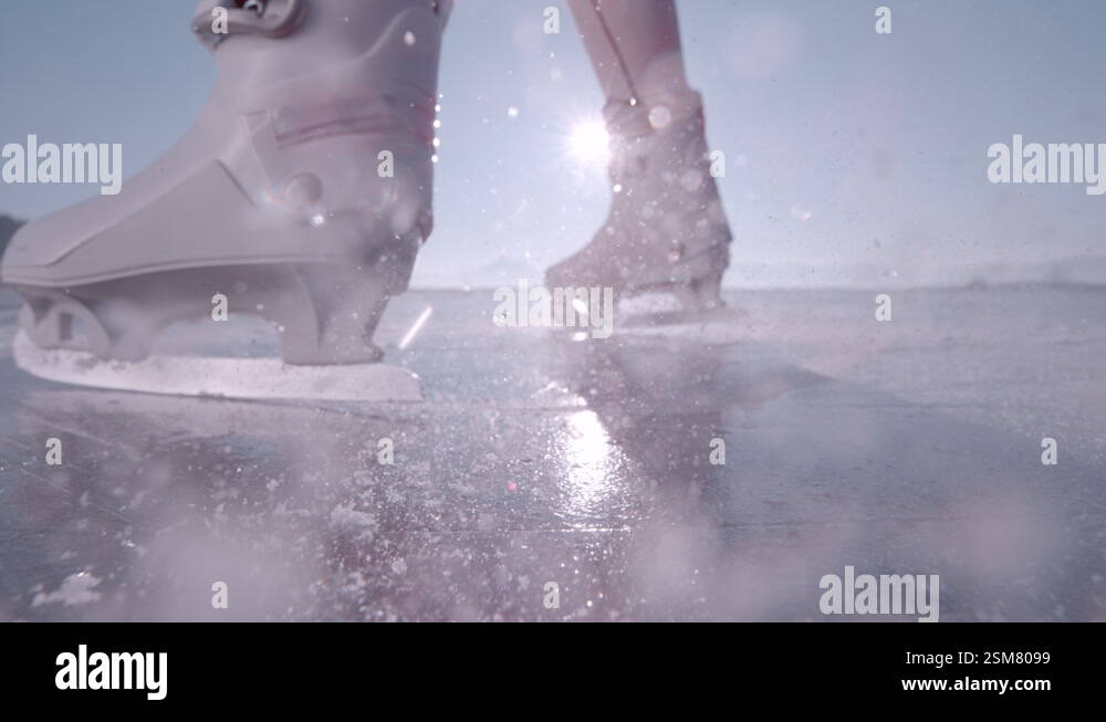 LENS FLARE, SUPER SLOW MOTION, CLOSE UP Woman brakes on her skates and ...