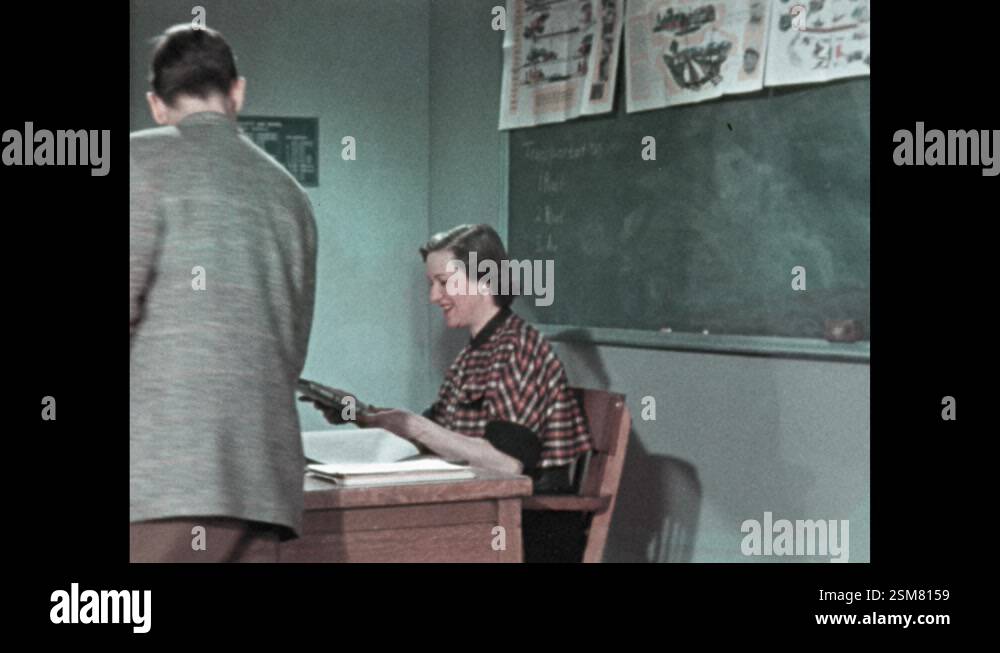 1950s: Student gives yearbook to teacher. Teacher smiles and pages ...