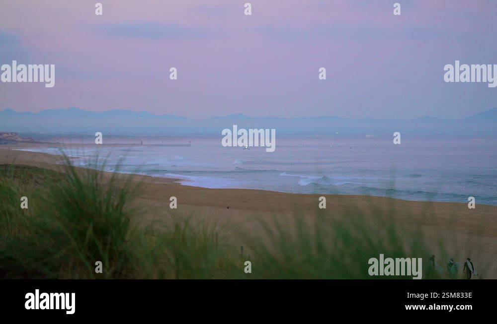 Cinematic pan right early morning pink orange purple dusk sunrise beach ...
