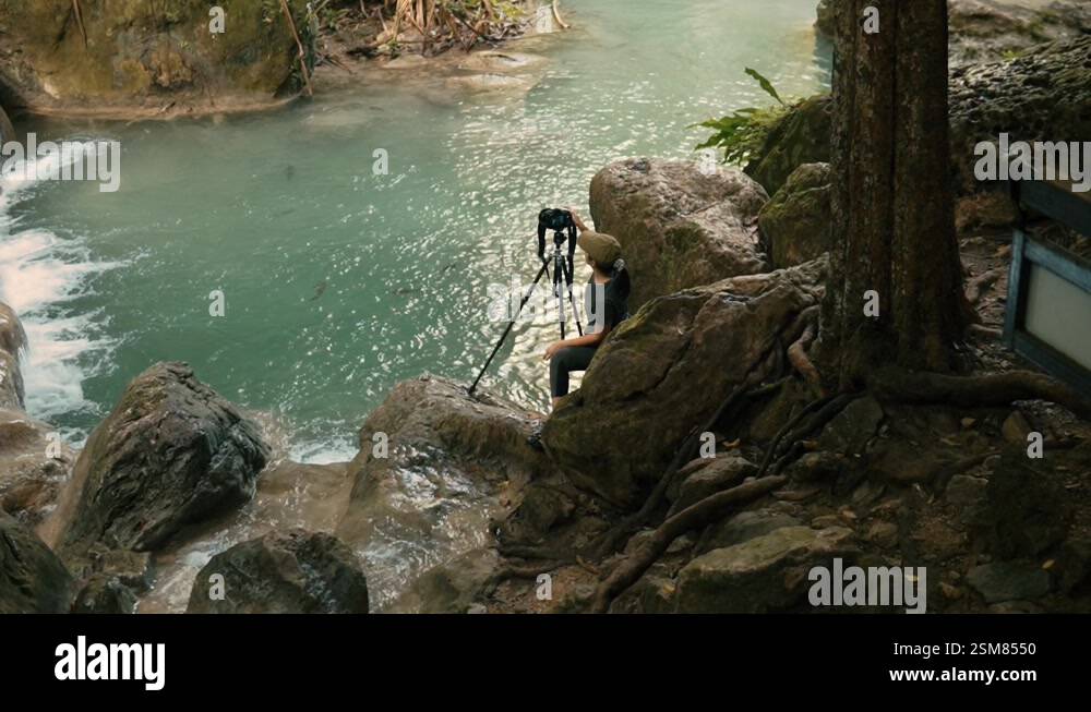 Photographer with a DSLR Camera on a Tripod Next to Waterfall at Erawan Stock Video Footage - Alamy