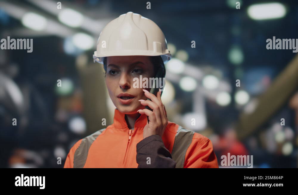 Portrait factory engineer talking cellphone on production. Woman ...