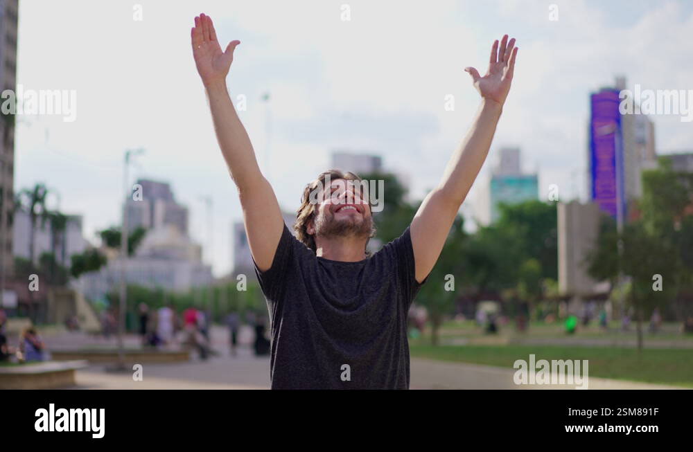 Exultant Young Man Expressing Hope and Faith with Uplifted Arms ...