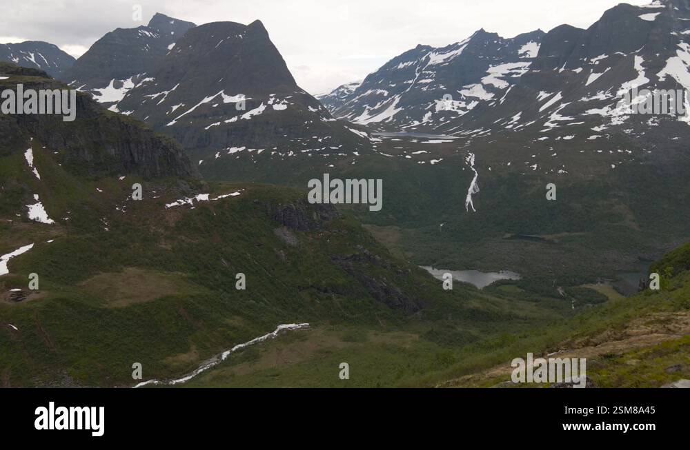 Areal drone footage with a man resting after a hike and admiring the ...