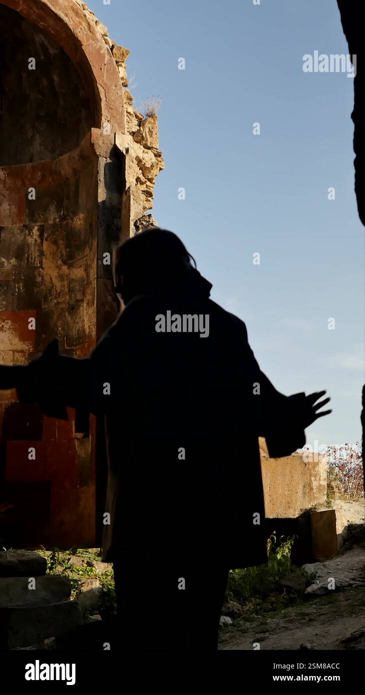 a young woman tourist and traveler walks among the ruins of an ancient ...