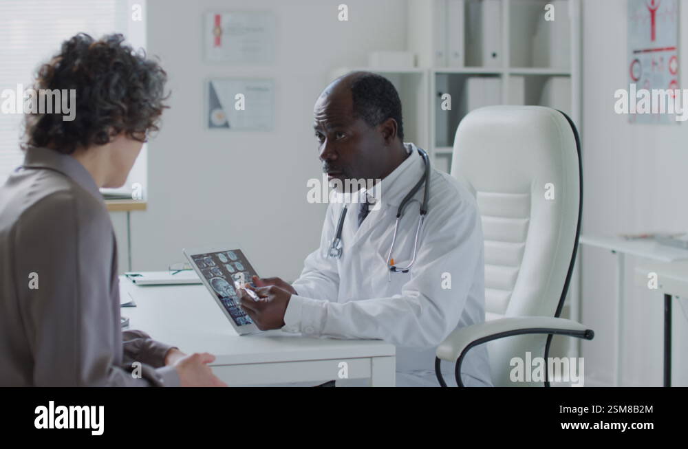 Doctor Showing and Explaining MRI Results to Patient Stock Video ...