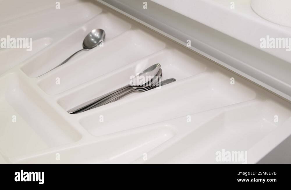 Using a kitchen cabinet to store kitchen utensils Stacking dishes in ...